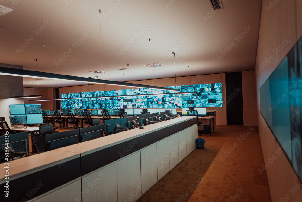 Empty interior of big modern security system control room, workstation ...