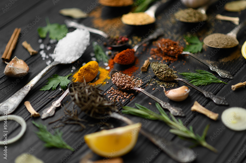 Colorful various herbs and spices for cooking on dark wooden rustic ...