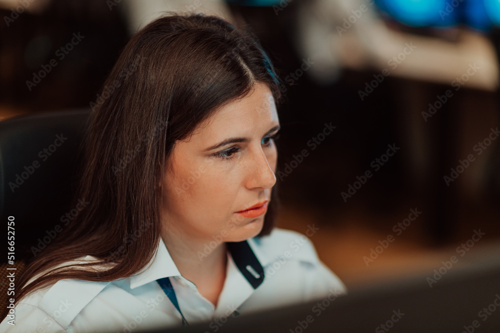 Female security operator working in a data system control room offices ...