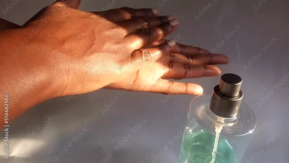 Vídeo do Stock: Brown,female hands using blue hand sanitizer spray. She ...