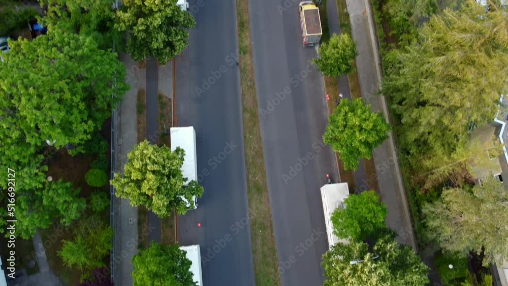 Cars drive on an avenue. Breathtaking aerial view flight tilt up drone ...