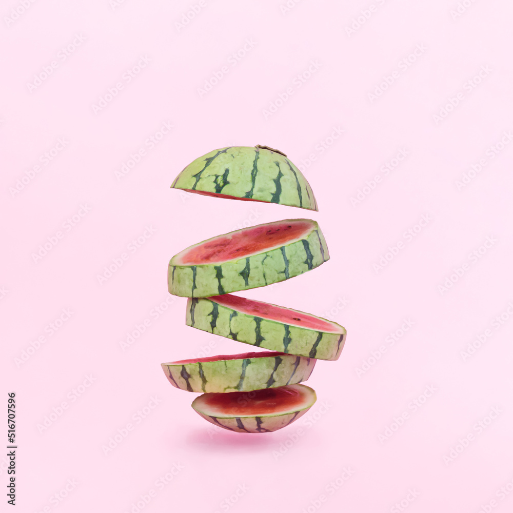 Watermelon sliced levitating on a pastel pink background. Summer ...