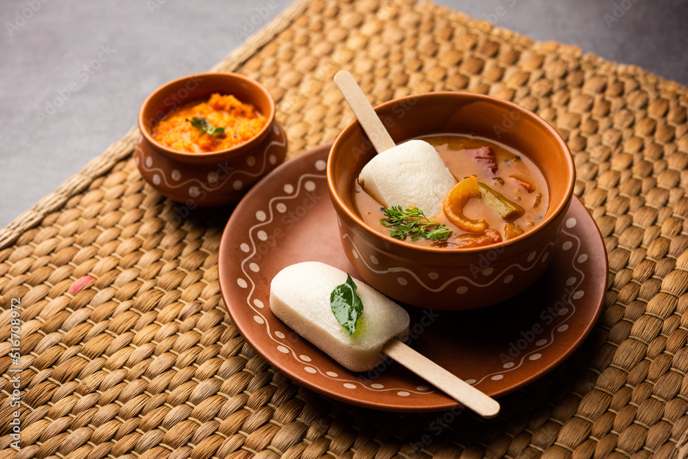 Idly lollipop or idli candy with stick served with sambar and chutney ...