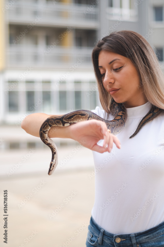 Long hair woman and a snake in the urban environment Stock Photo ...