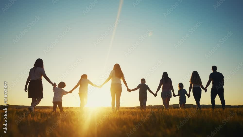 community large family in the park. a large group of people holding ...
