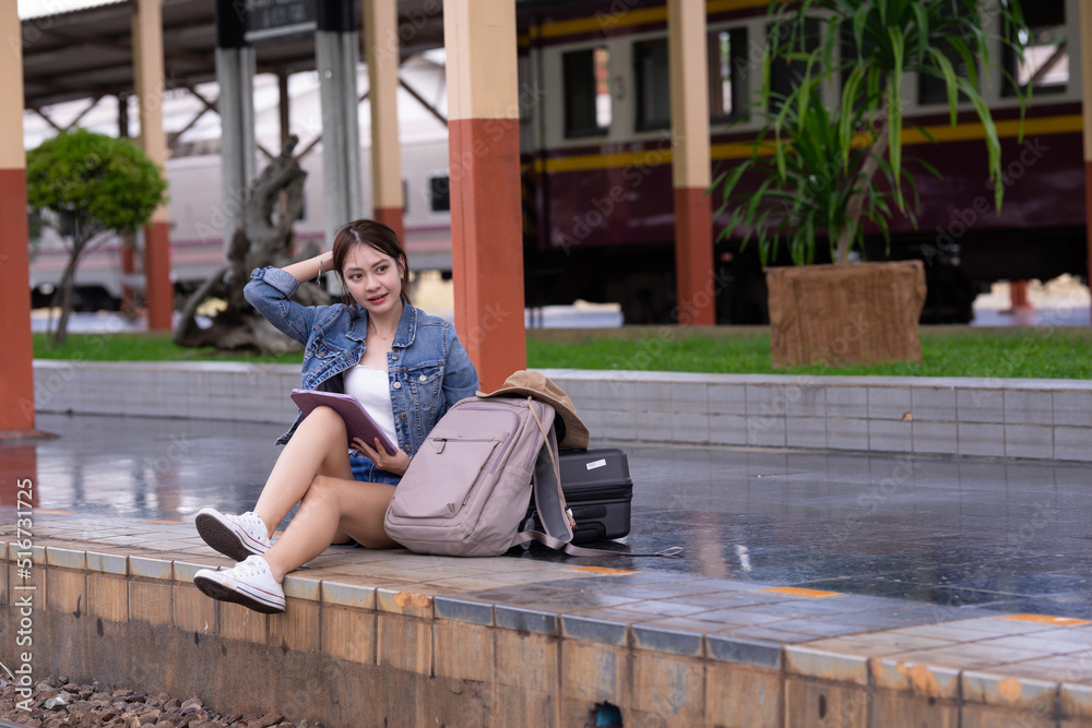 Asian tourist teenage girl at train station using smartphone map ...