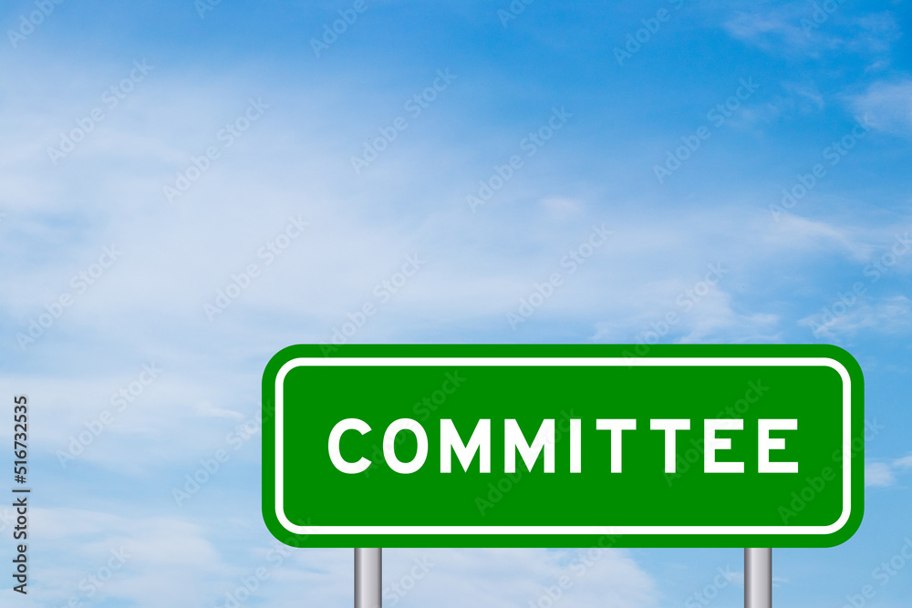 Green color transportation sign with word commitee on blue sky with ...