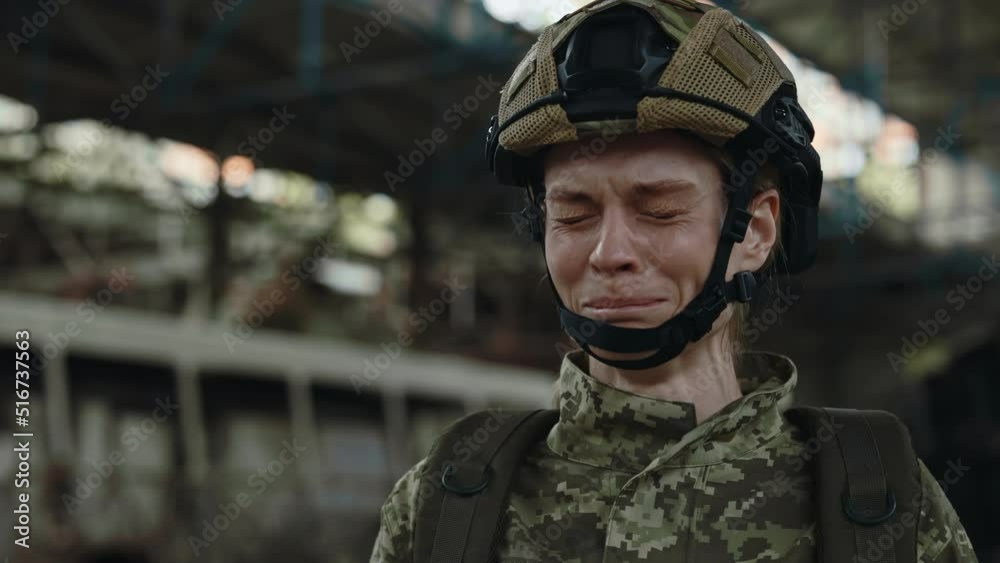 Military woman soldier in uniform and helmet crying while having hard ...