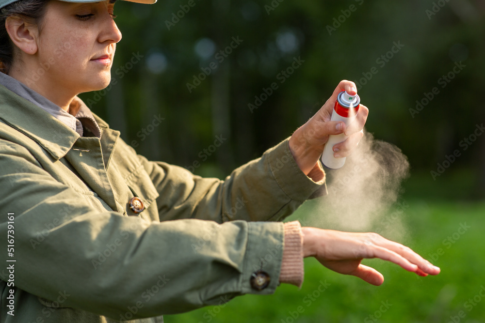 health care, protection and people concept - woman spraying insect ...