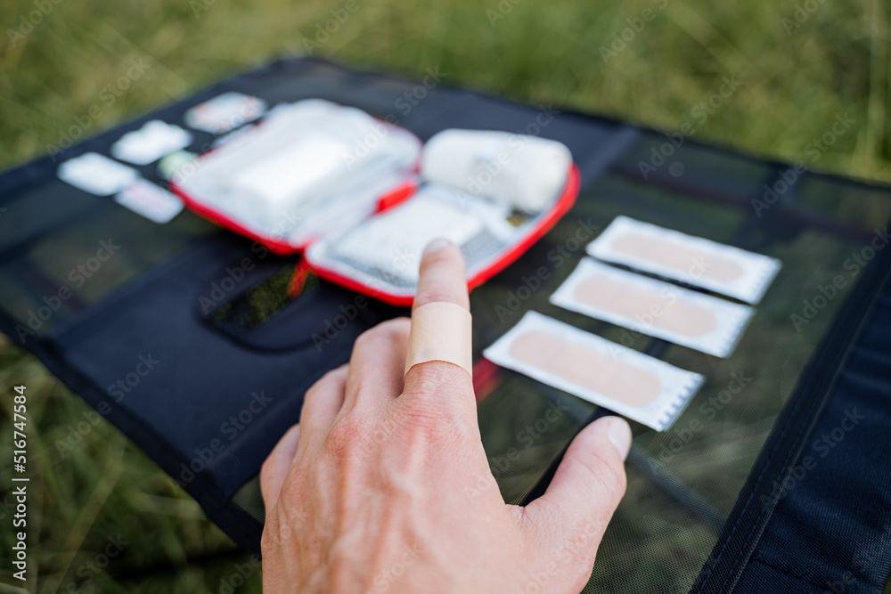 First aid kit for cuts Adhesive plaster glued to the finger, injured ...