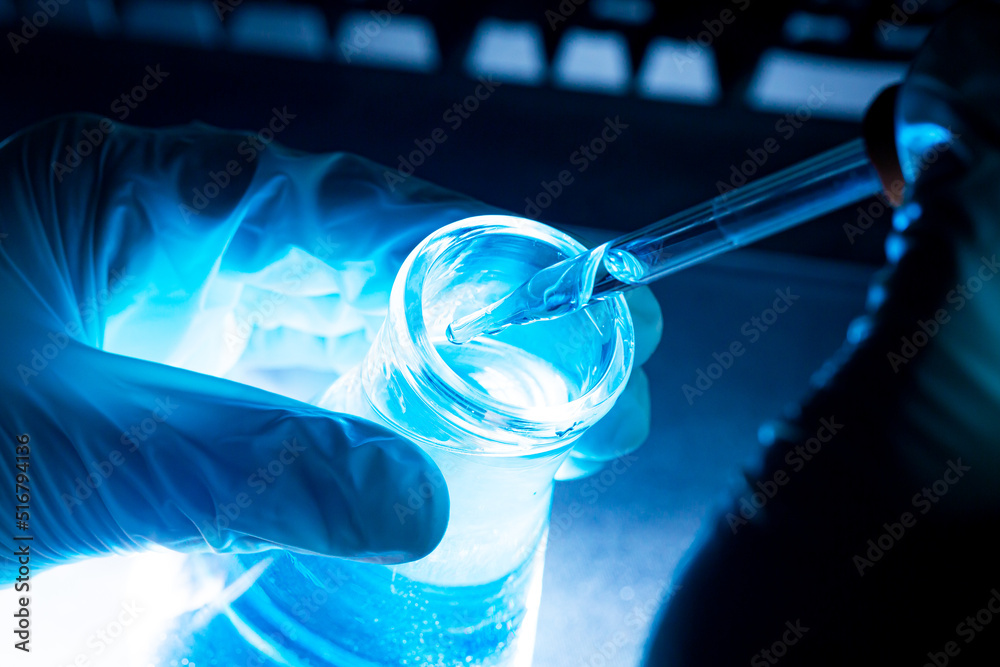 Blue science experiment glass tube,Researchers with chemistry test ...