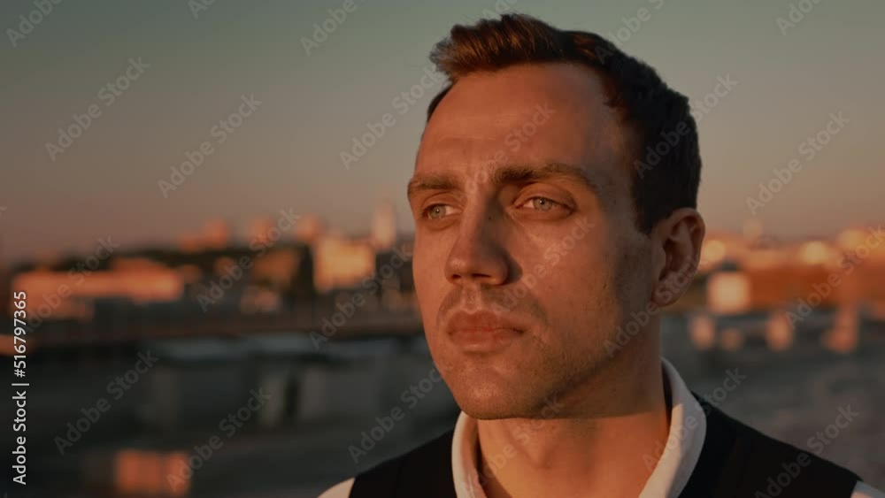 Man looks around, stands on roof, on the street, looks at houses from ...