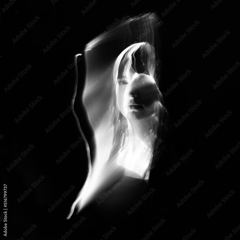 Abstract human silhouette in light trails of light painting with white ...