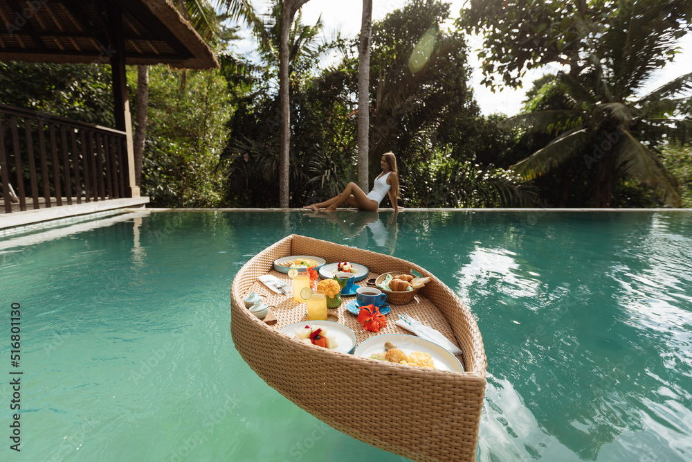 Breakfast in swimming pool, floating breakfast set in tray in resort ...