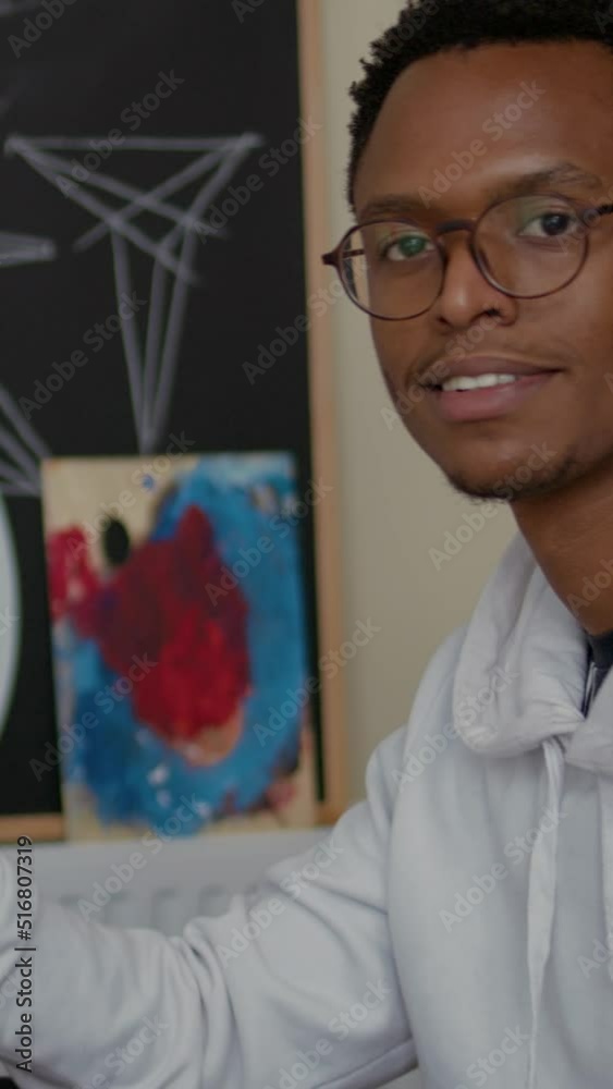 Vertical video: Portrait of smiling man drawing vase sketch on white ...