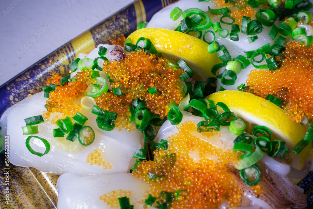 A takeout Ika Sushi (Squid Sushi) topping with Tobiko (Tobikko, Flying ...