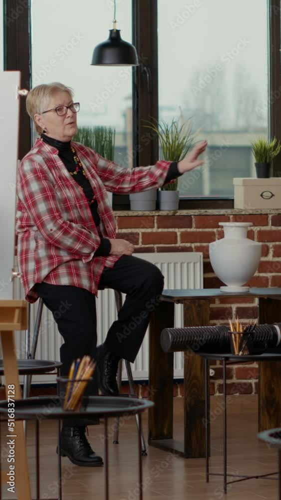 Vertical video: Elder artist explaining drawing skills to people at art ...