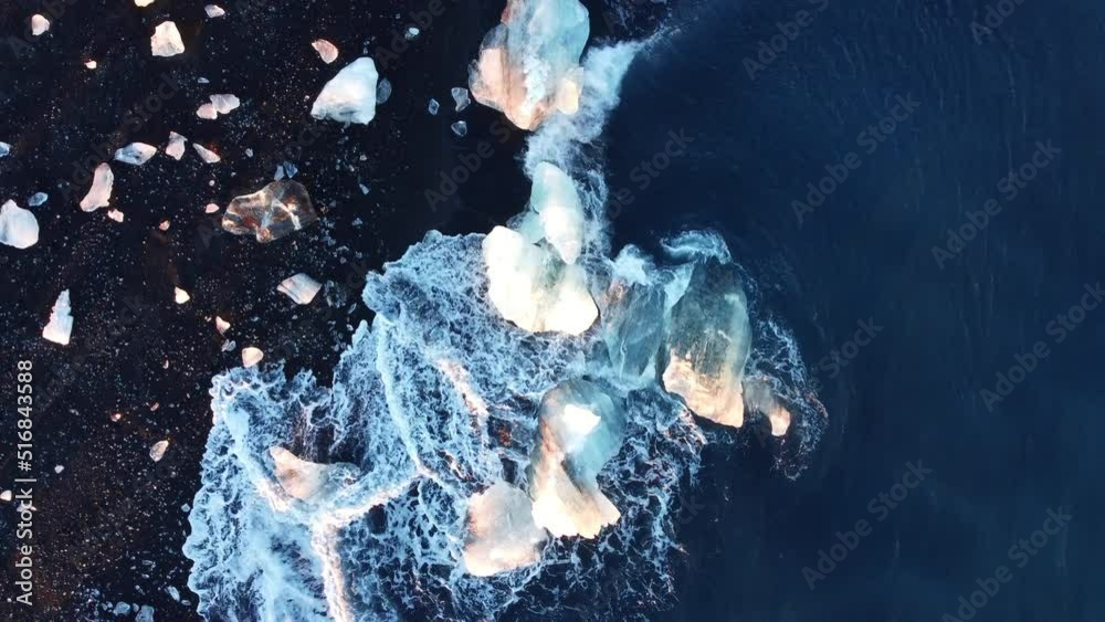 Pure blue Ocean water waves with light reflections crush Icebergs at ...