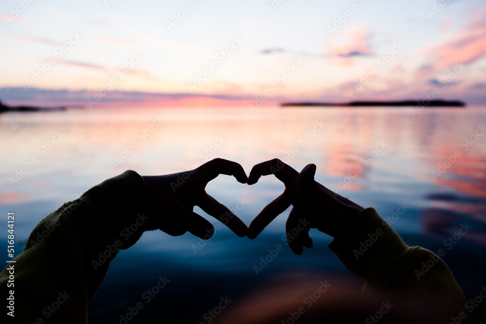 Heart shape hand gesture made with fingers against colorful out of ...