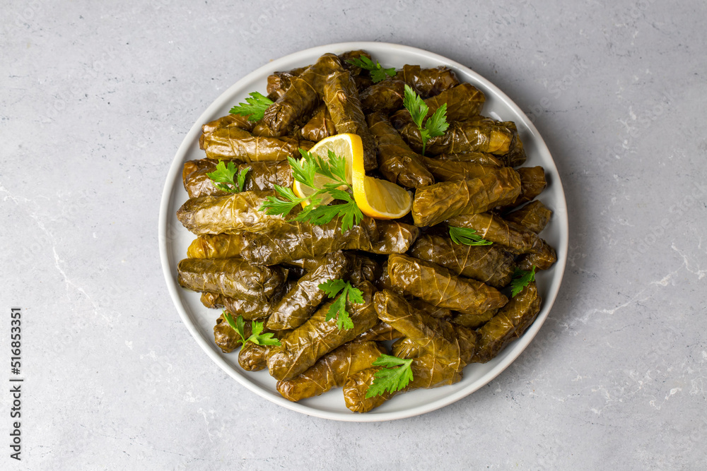 Delicious dolma (sarma) stuffed grape leaves rice, white yogurt sauce ...
