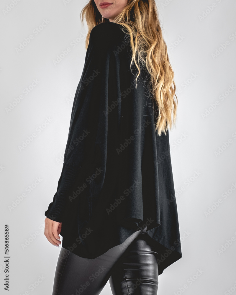 Beautiful blonde model girl without face in black poncho style sweater ...