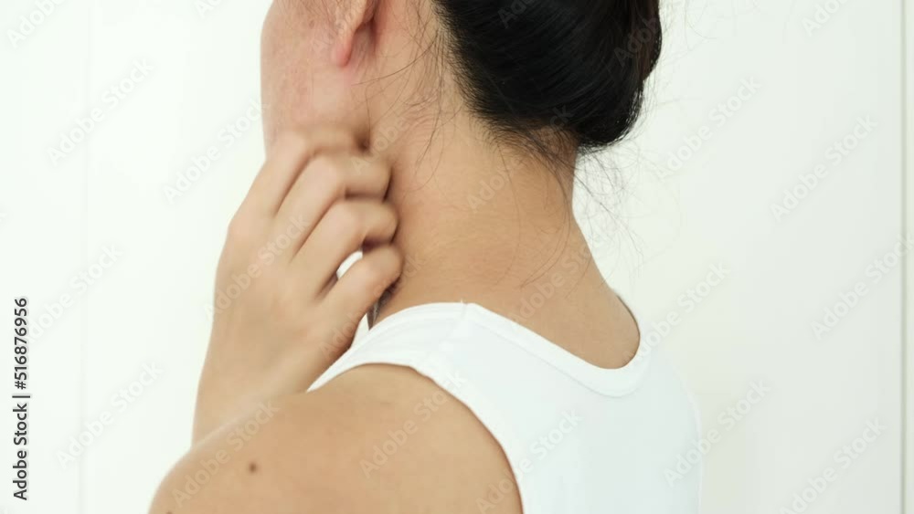 The woman had itchy skin on her neck, she scratched her neck with her ...