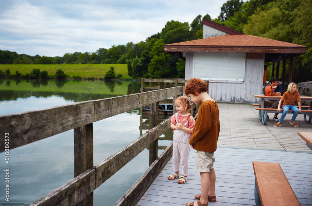 kids enjoy the day at the lake in city park. family relaxing on the ...