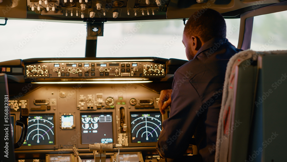 African American Captain Inserting Destination Coordinates To Help Pilot Before Takeoff Flying