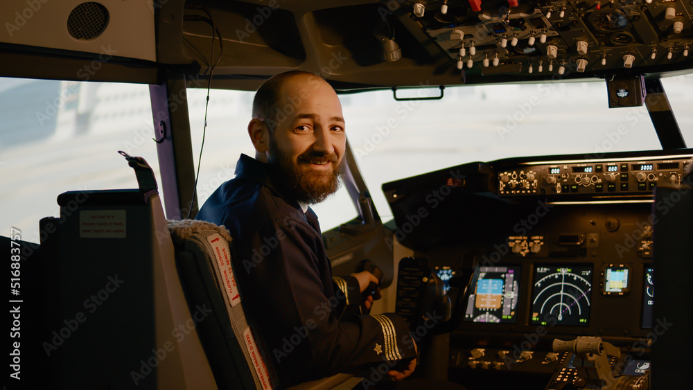 Portrait of airplane captain preparing to fly aircraft in cockpit ...