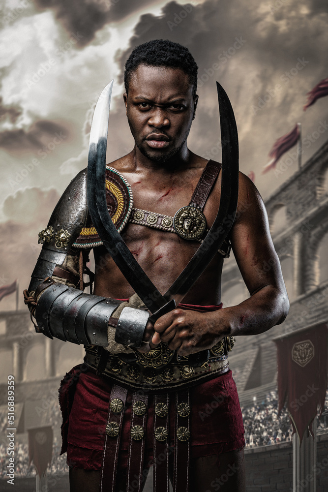 Shot of furious african gladiator holding two swords in cross in arena ...