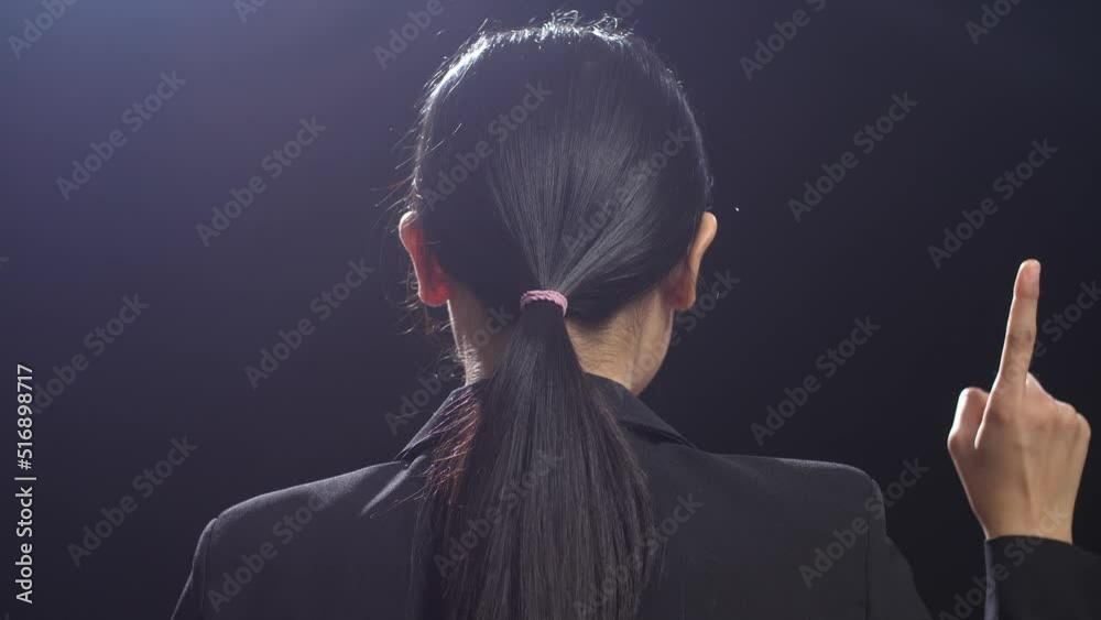 Back View Of Asian Speaker Woman In Business Suit Showing Index Fingers ...