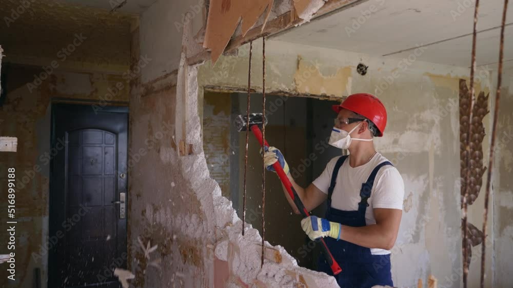 Contractor wrecks wall with sledgehammer making hole for rearrangement ...
