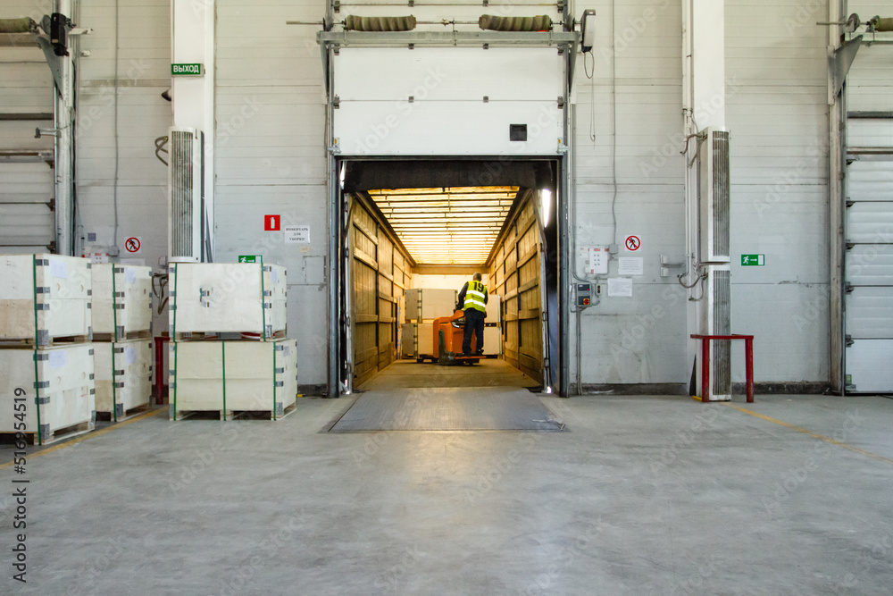 Interior of a modern warehouse storage of retail shop with pallet truck ...