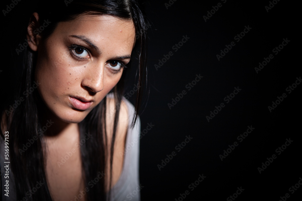 Dark Fear. A concerned look on the face of a beautiful young mixed-race ...