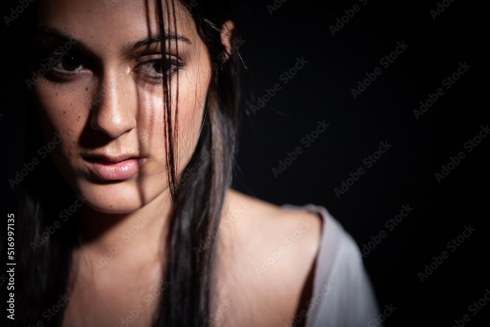 Dark Fear. A concerned look on the face of a beautiful young mixed-race ...