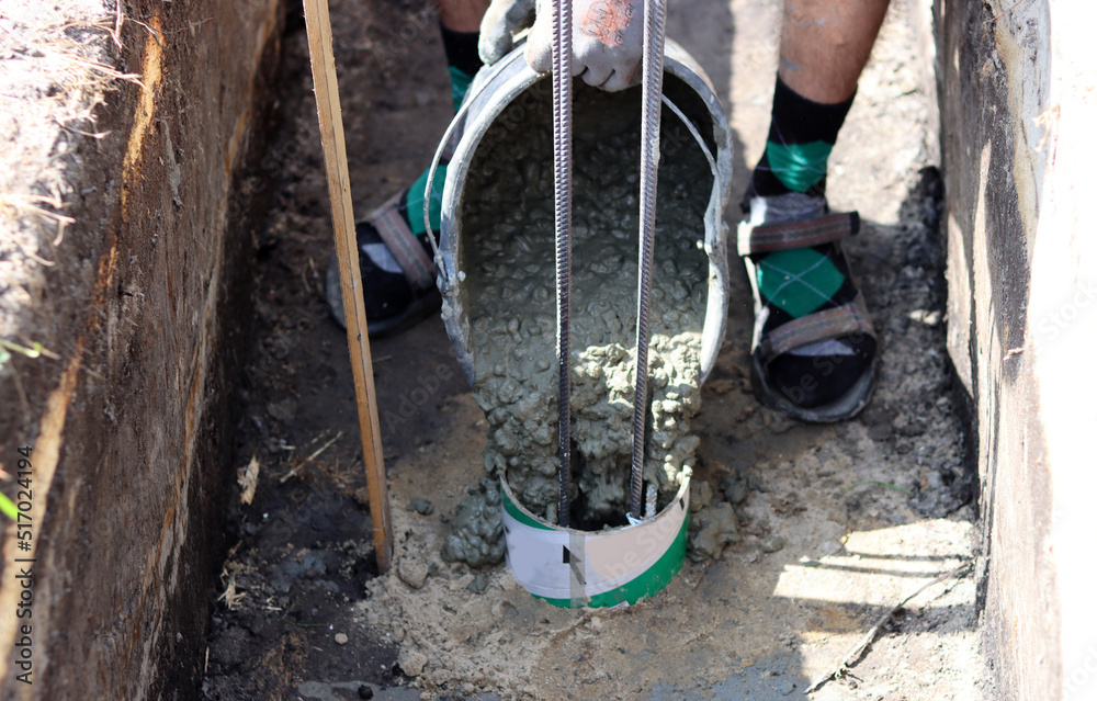 Cement work in progress. Foundation strength work. Bucket of concrete ...