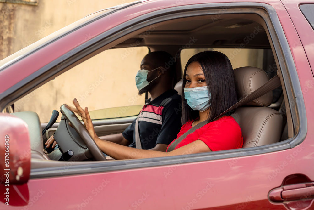 road trip african female driver wearing nose makes with her male ...
