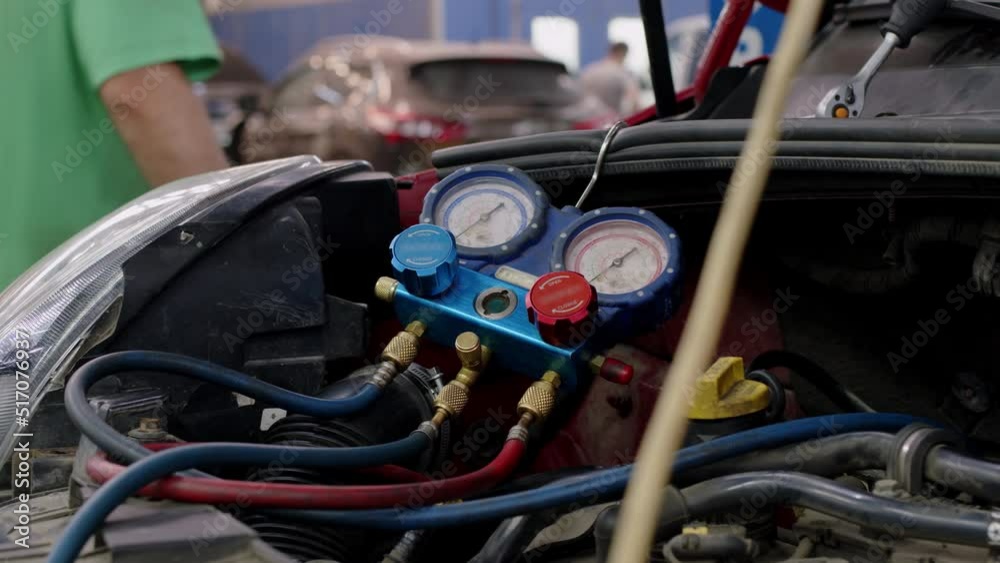 Under hood of open car lies system of manometers for refueling air ...