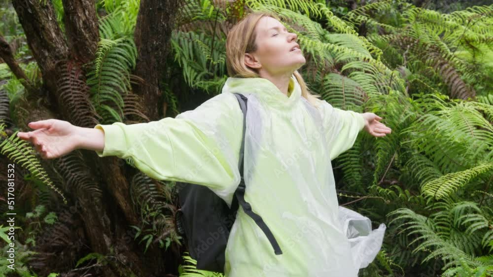Free Happy Young Hiker Woman in clear raincoat looking up with raised ...