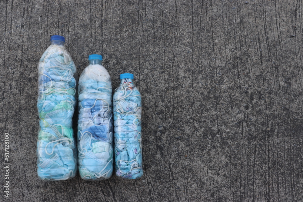 used mask Collected and disposed of in clear plastic bottles, covered ...