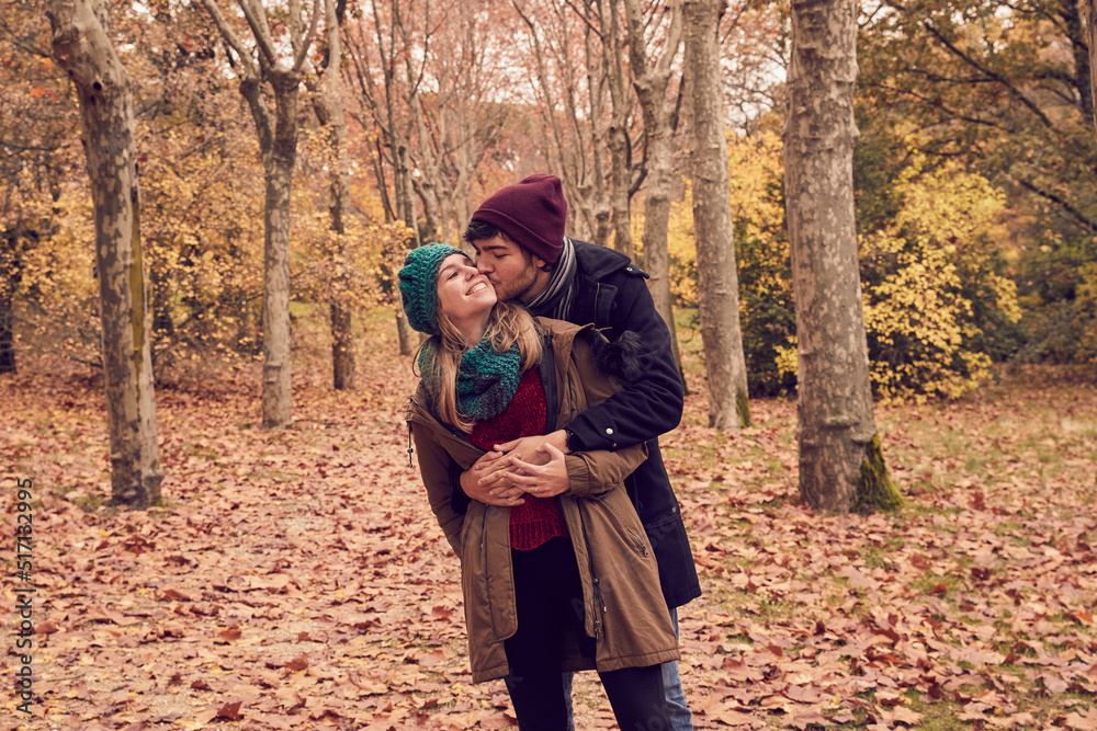 White Caucasian man hugging his girlfriend from behind giving her a ...