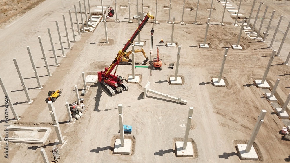large construction site with precast concrete parts, excavators and a ...