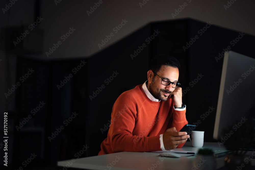 A man taking a break from networking, using a mobile phone. Stock Photo ...