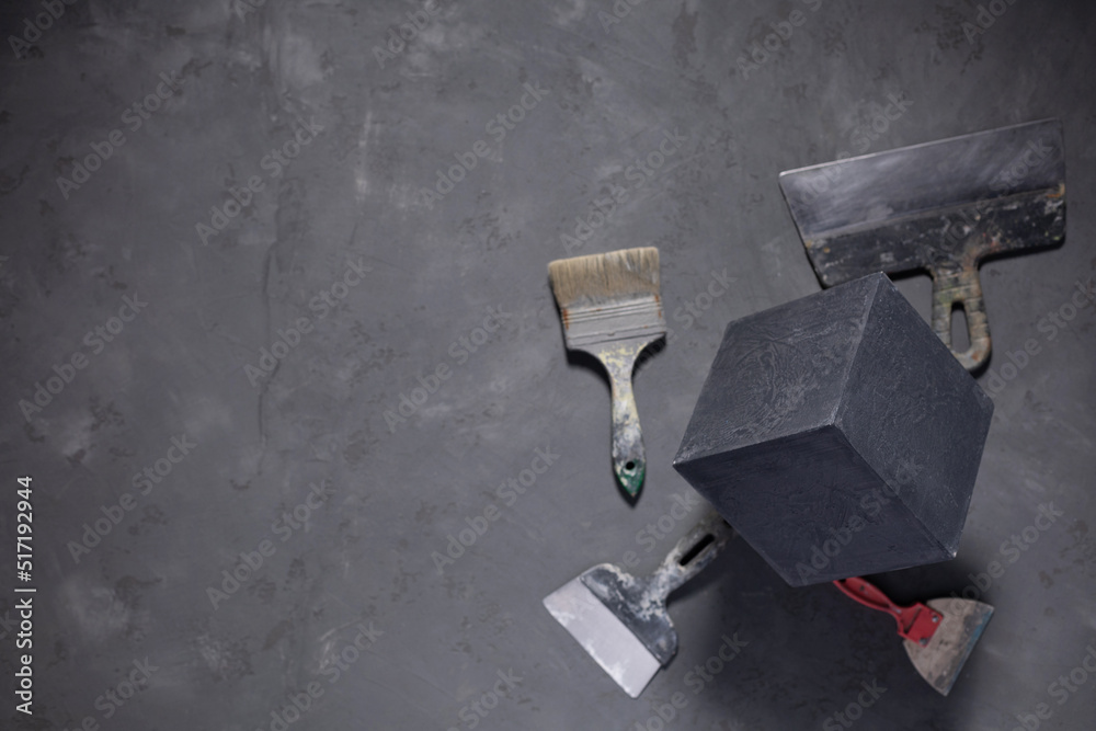 Concrete cube and construction work tools on floor background texture ...