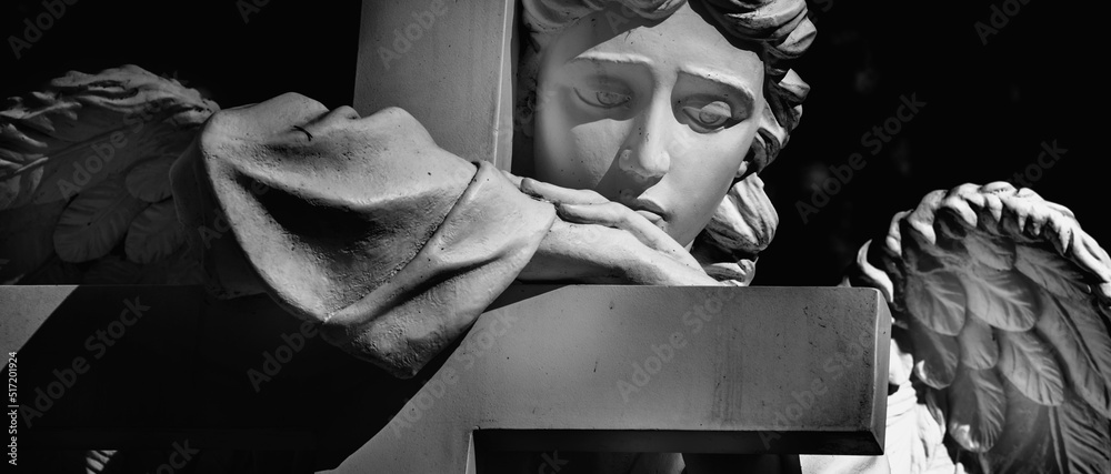 Angel with cross against dark background as symbol of Christianity ...