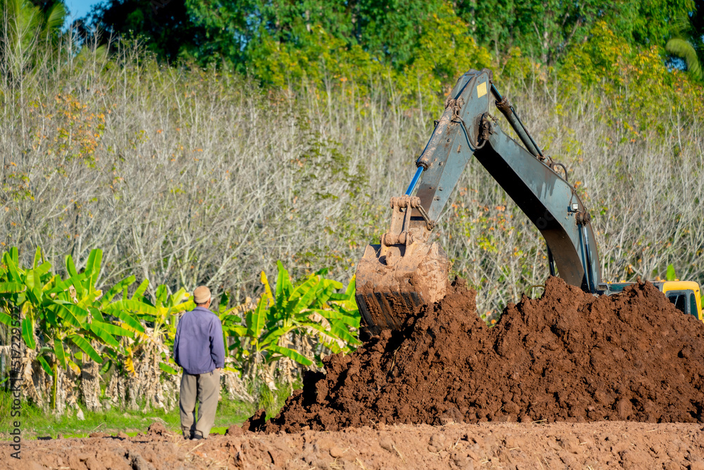 Excavator machine working and digging ground on blurred background ...