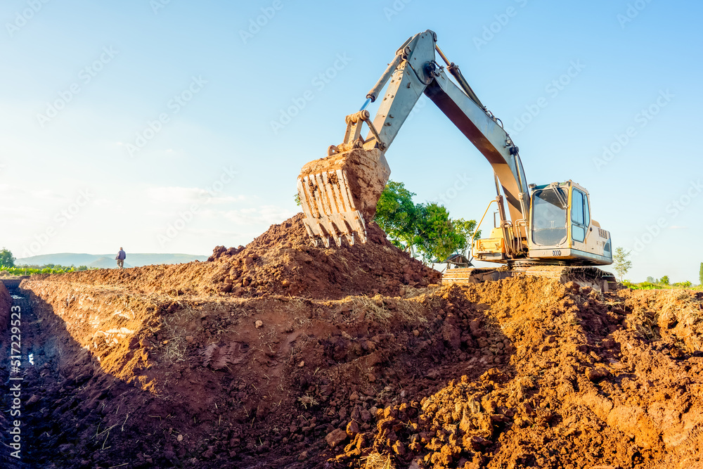 Excavator machine working and digging ground on blurred background ...