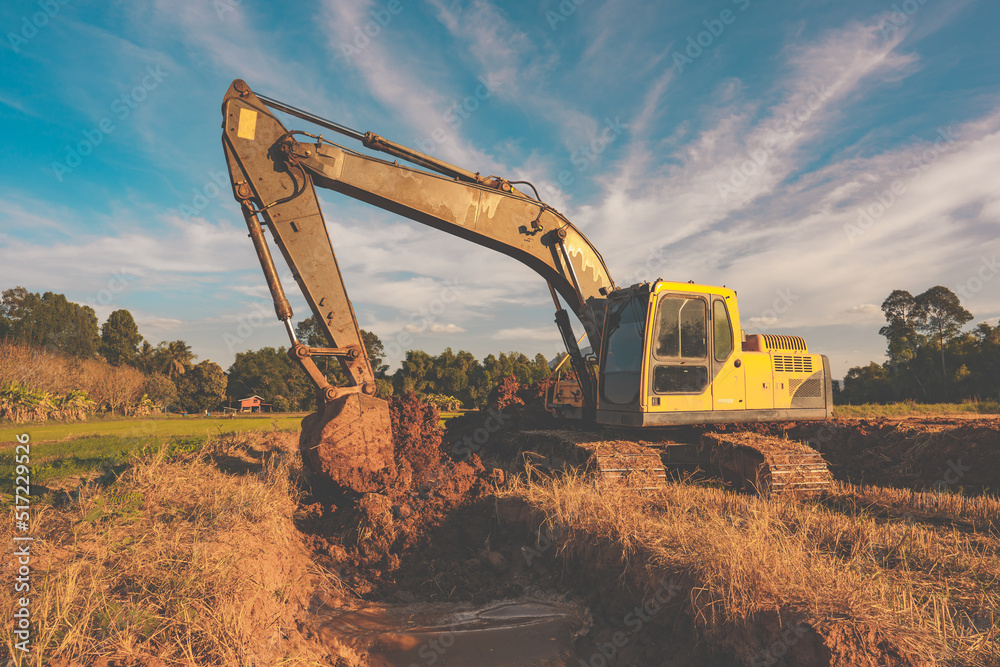 Excavator machine working and digging ground on blurred background ...