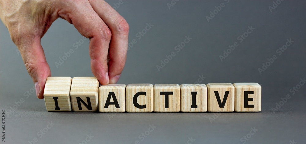 Active or inactive symbol. Businessman turns wooden cubes and changes ...