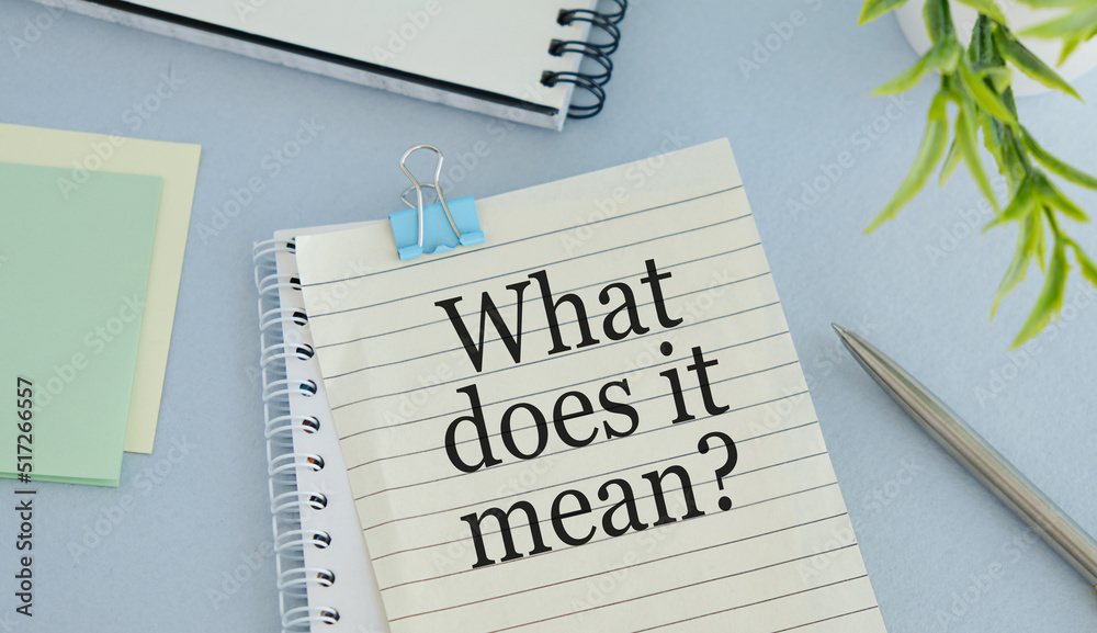 text what does it mean written on notepad with pencils on blue ...